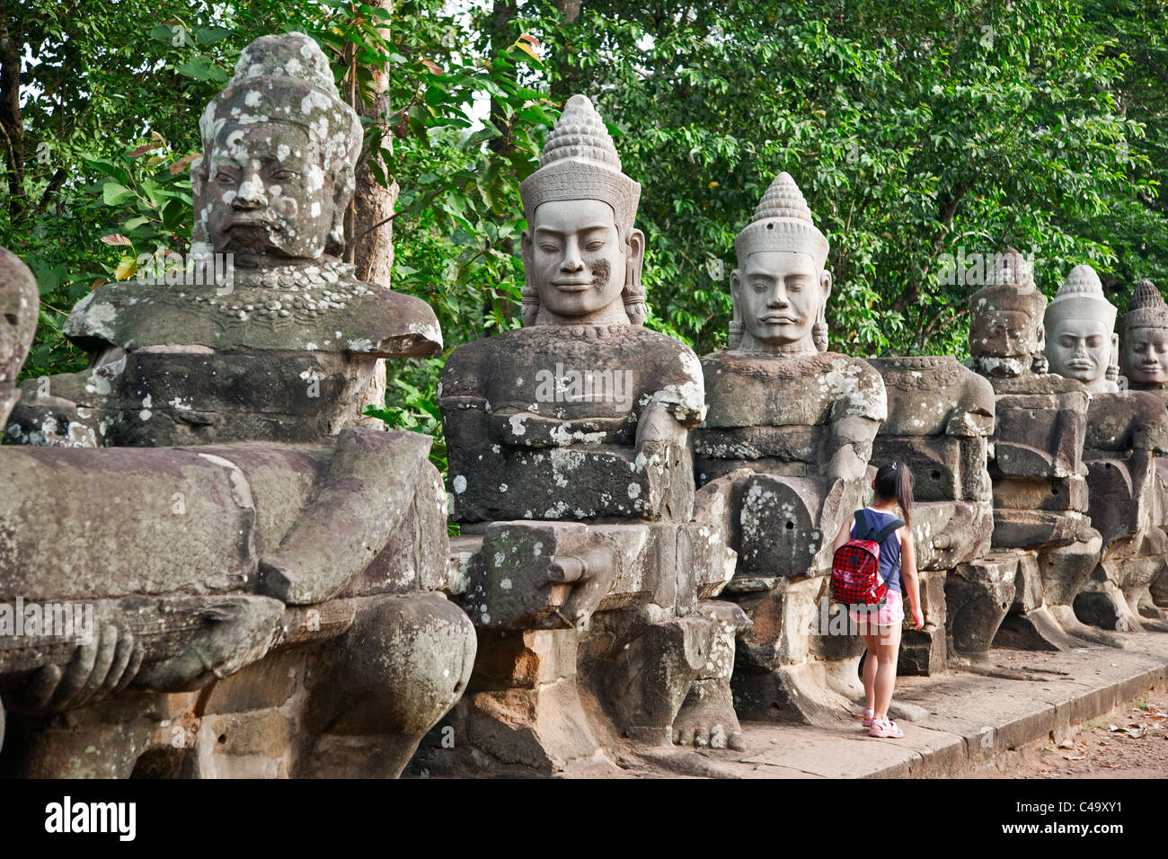 Girl looking at the god statues. The avenue of Gods and Asaras. South ...