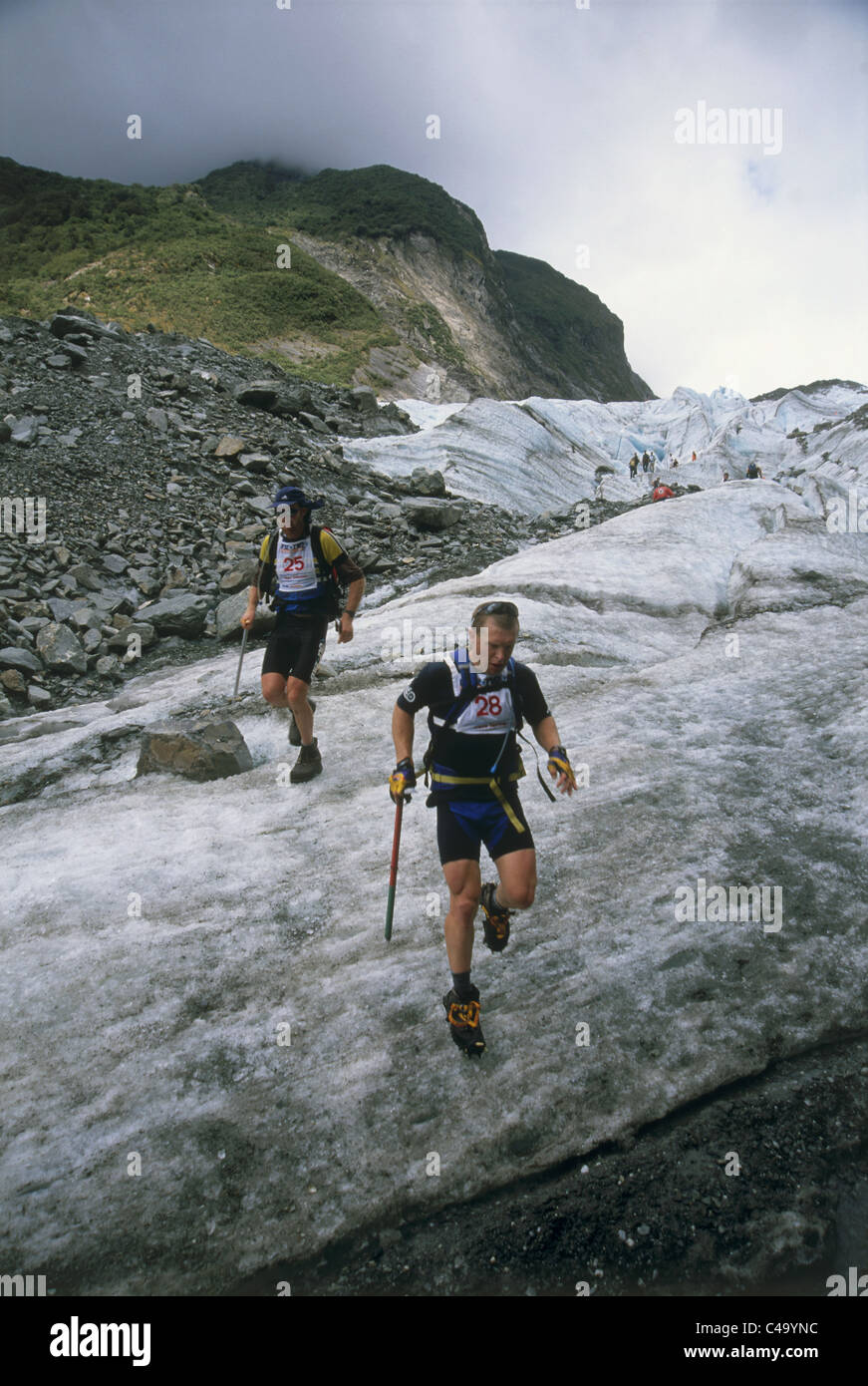 Photograph of two man running across a glacier in New Zealand Stock ...