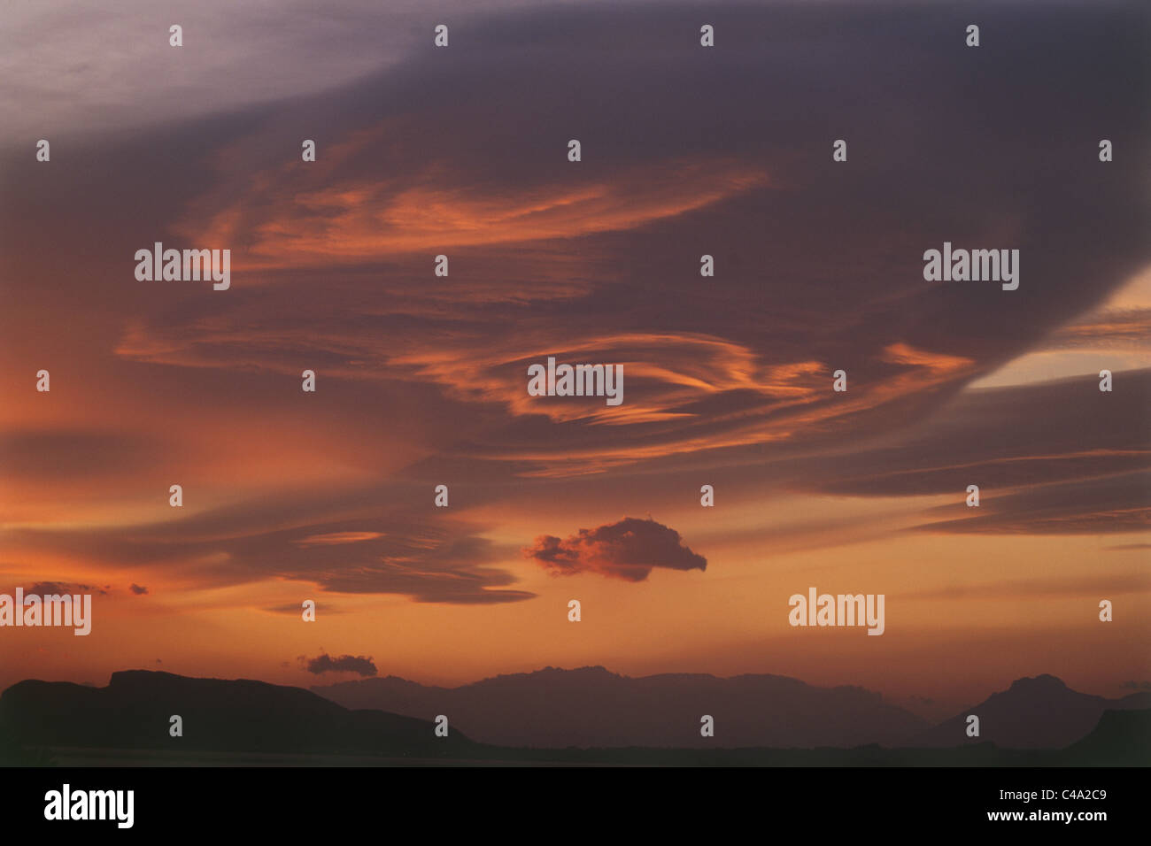 Photograph of the cloudy sky over Italy at sunset Stock Photo - Alamy