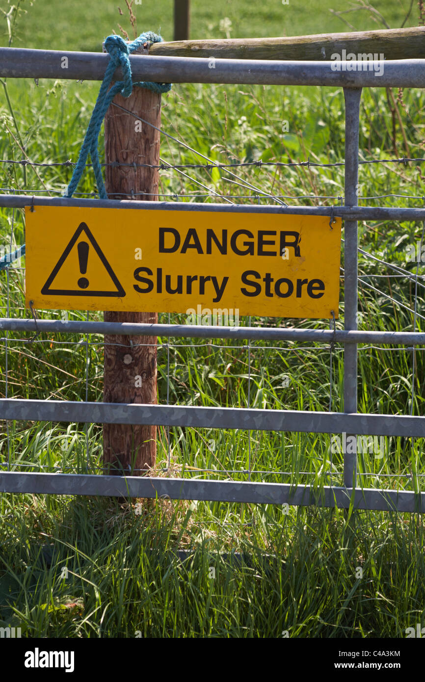 Danger slurry store notice on gate by field in the countryside in UK ...