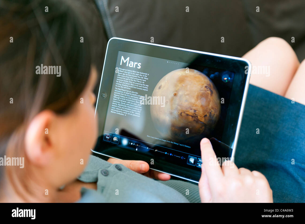 close up of woman using iPad digital tablet computer to learn about ...