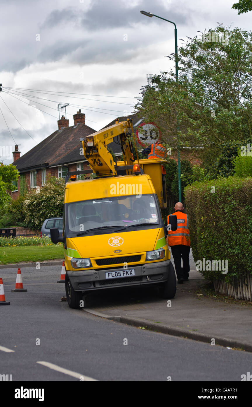 Workman erecting speed sign on urban, residential road Stock Photo - Alamy