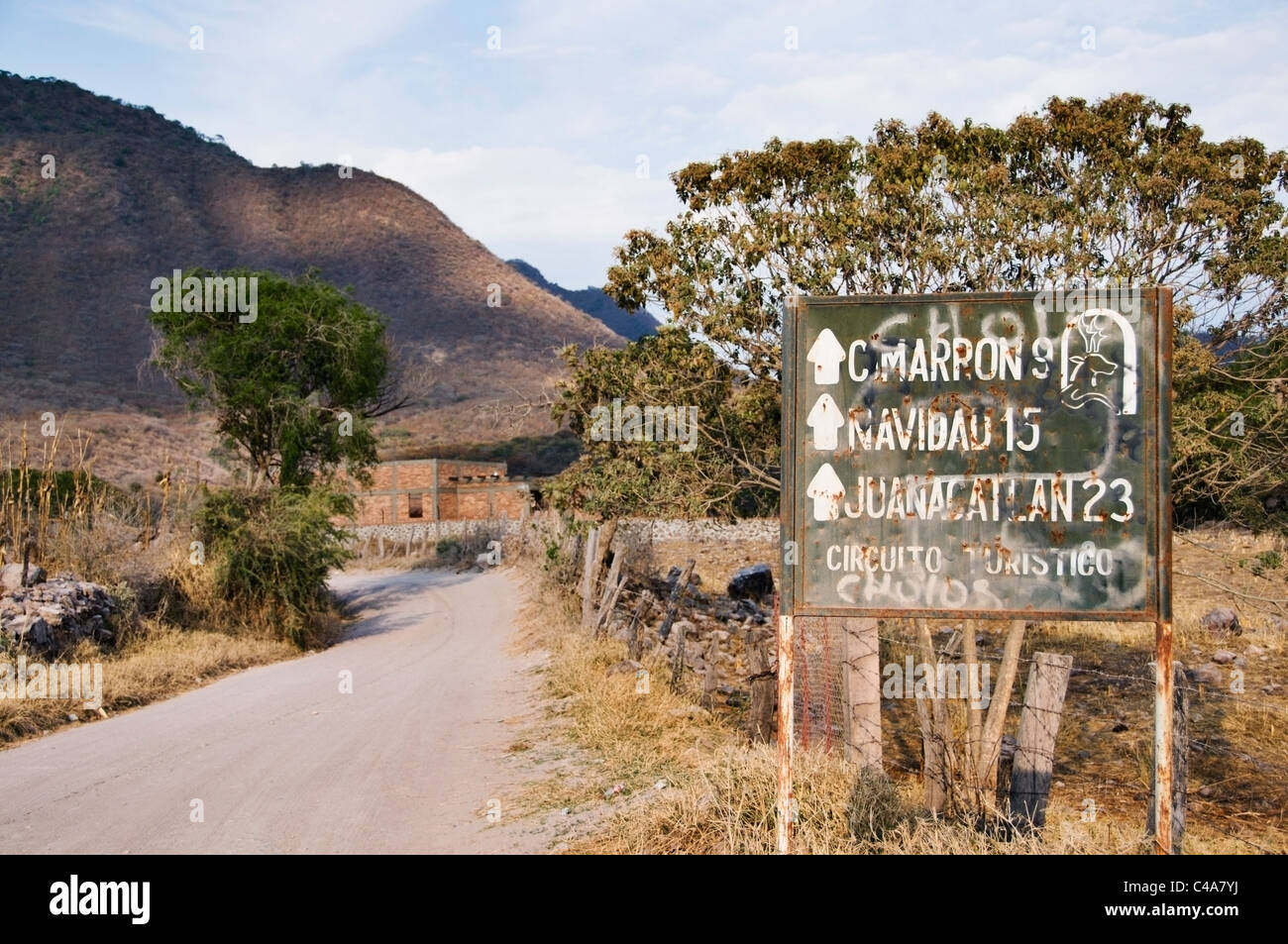 A rusty road sign points the way to a seldom used scenic loop on a dirt ...