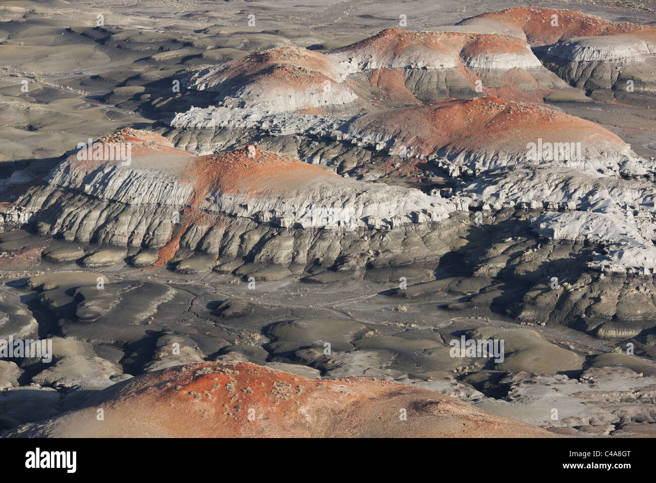 AERIAL VIEW. Badlands of sedimentary rock with colorful strata. Bisti ...