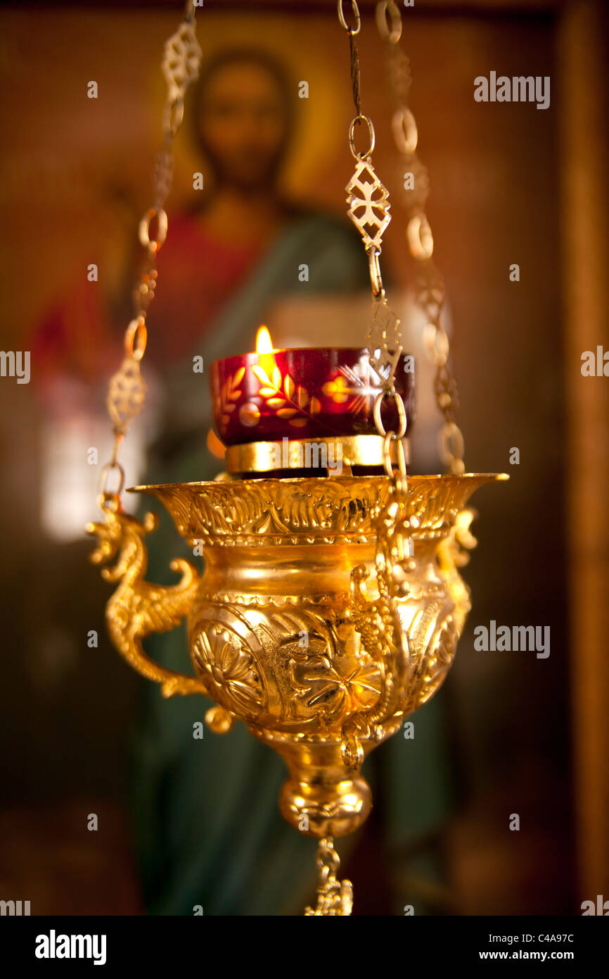 painting of Jesus behind a golden candle light at the village church in ...
