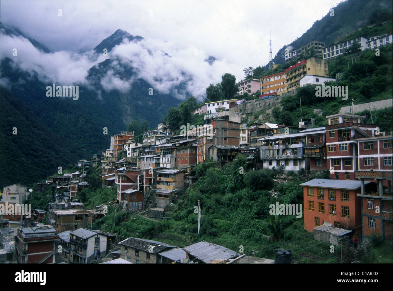 Photograph of a small Tibatian town on the slope of a mountain in Tibet ...