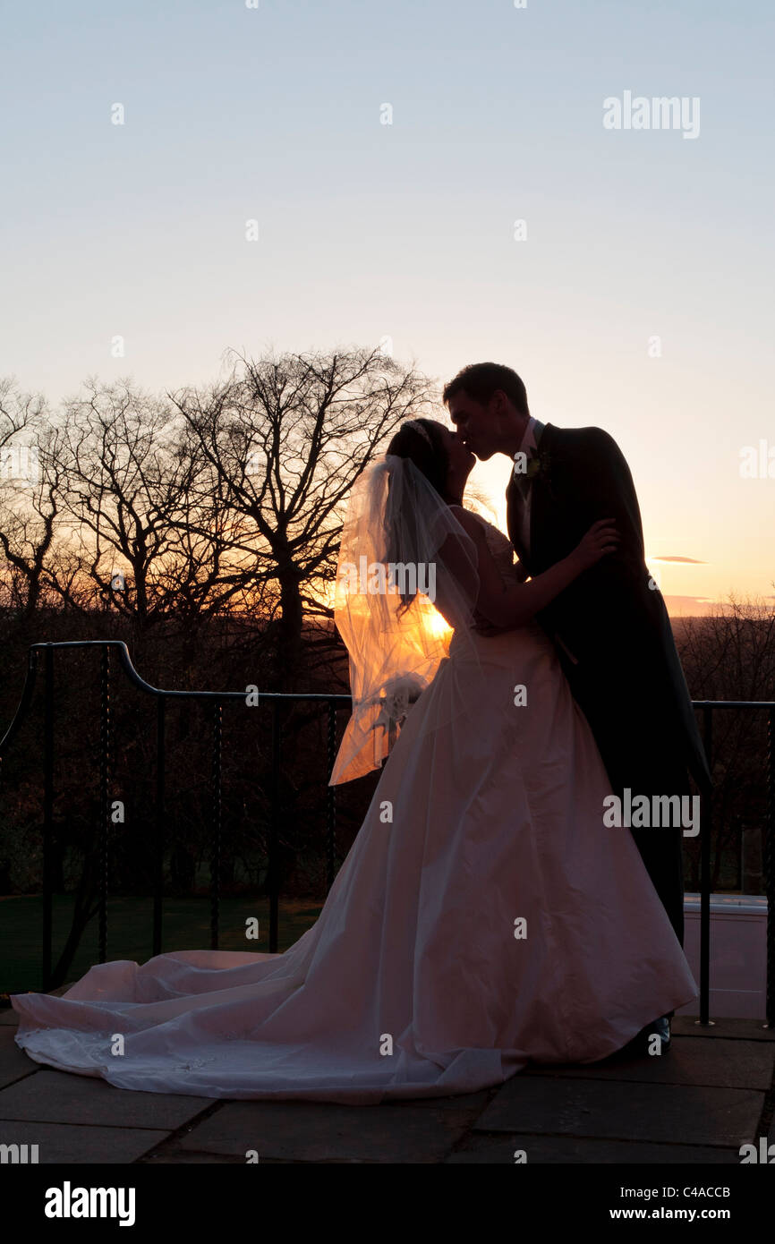 Bride And Groom Kissing Sunset