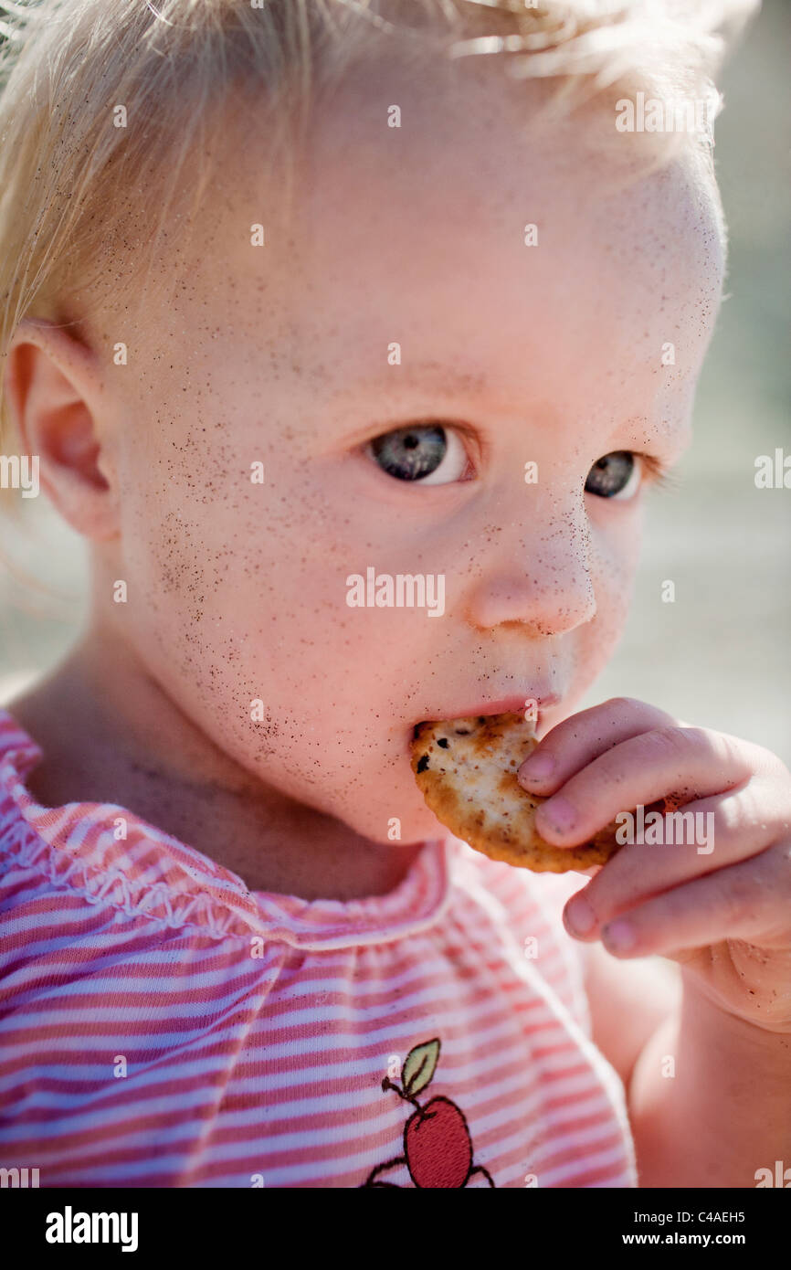 One Year Old Baby Eating Cracker on the Beach Stock Photo - Alamy