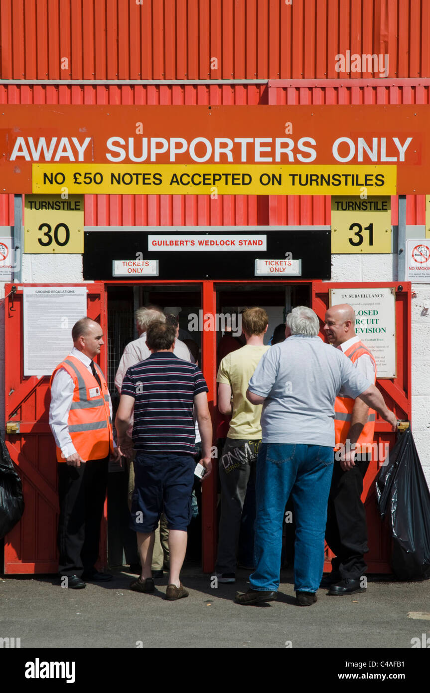 Away fans enter the turnstile at Ashton Gate, Bristol. The sign above ...