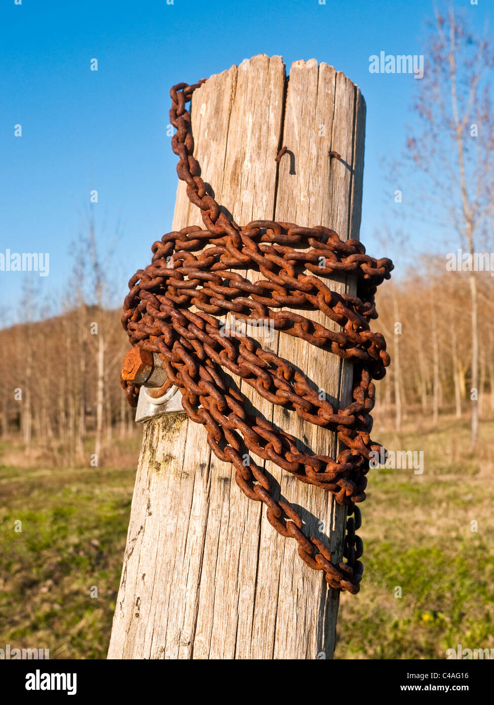 Old rusty chain wrapped around gatepost - France Stock Photo - Alamy