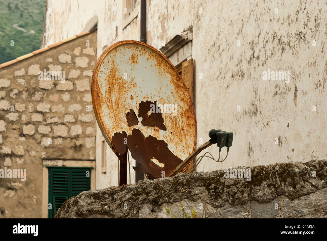 An old and rusting domestic satellite dish Stock Photo - Alamy