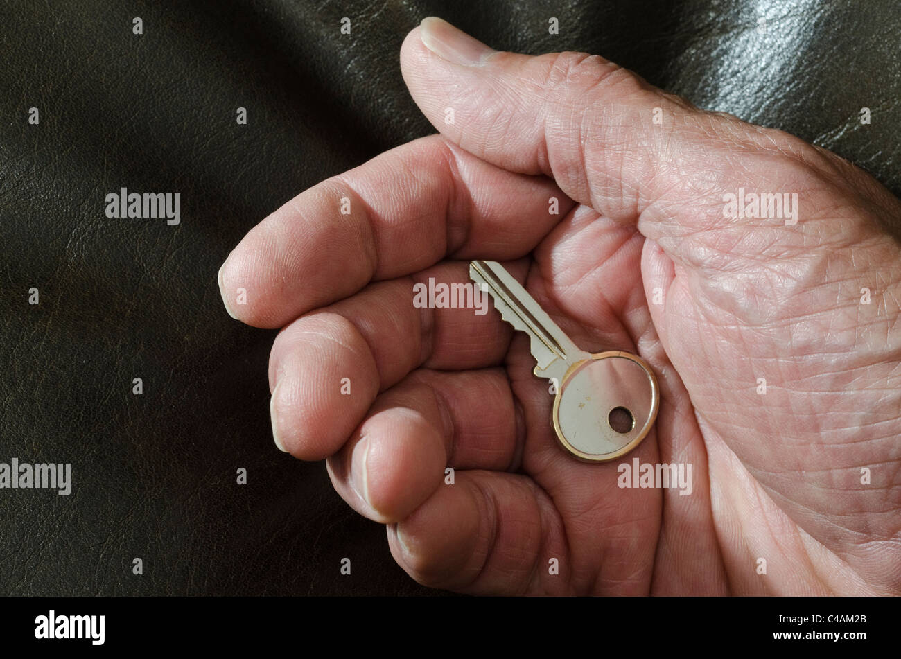 small key in palm of hand Stock Photo - Alamy