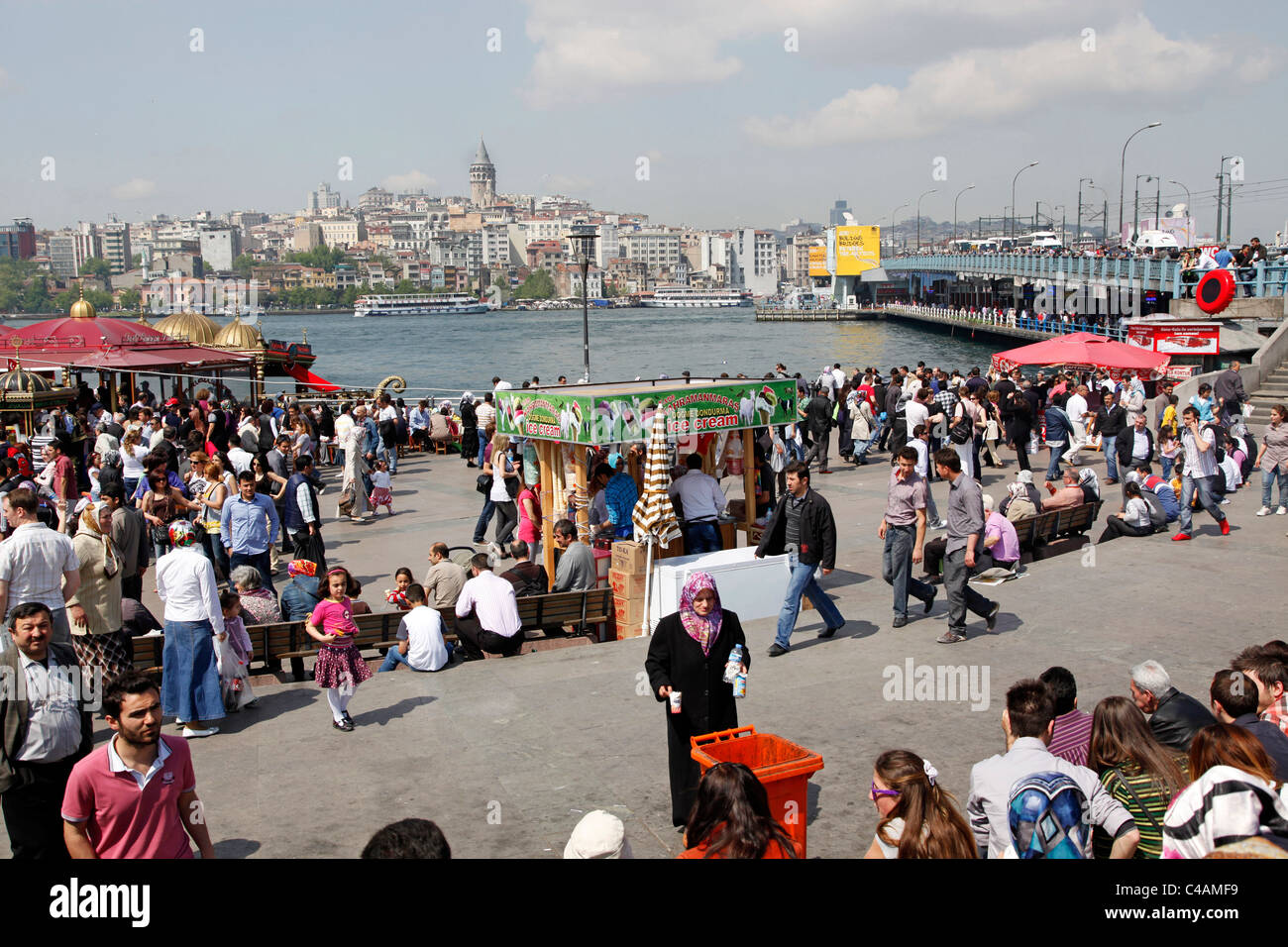 Crowds of people on the waterfront in Istanbul Harbour in Istanbul ...