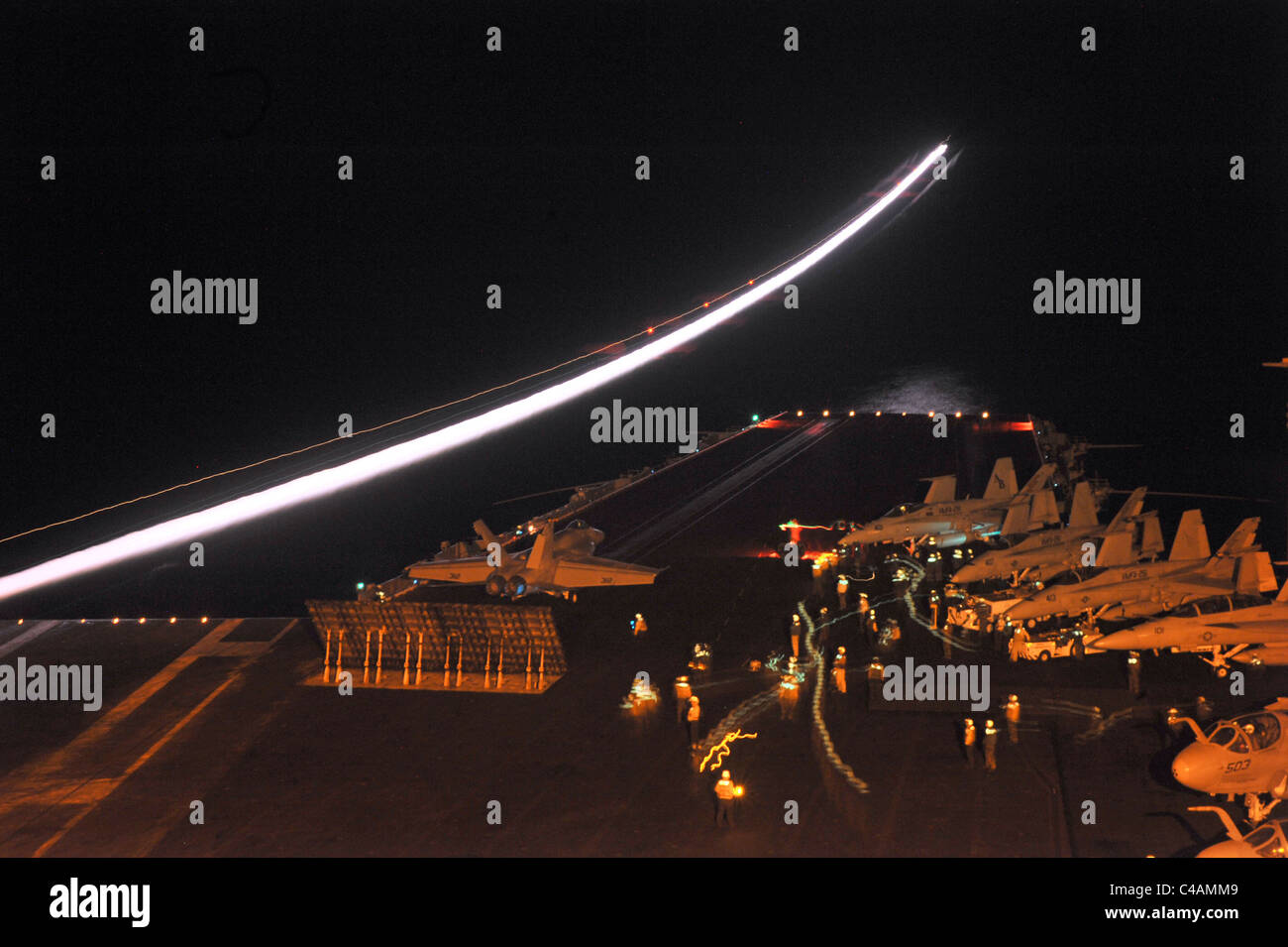 A US Navy F/A-18E Super Hornet fighter aircraft during night operations ...