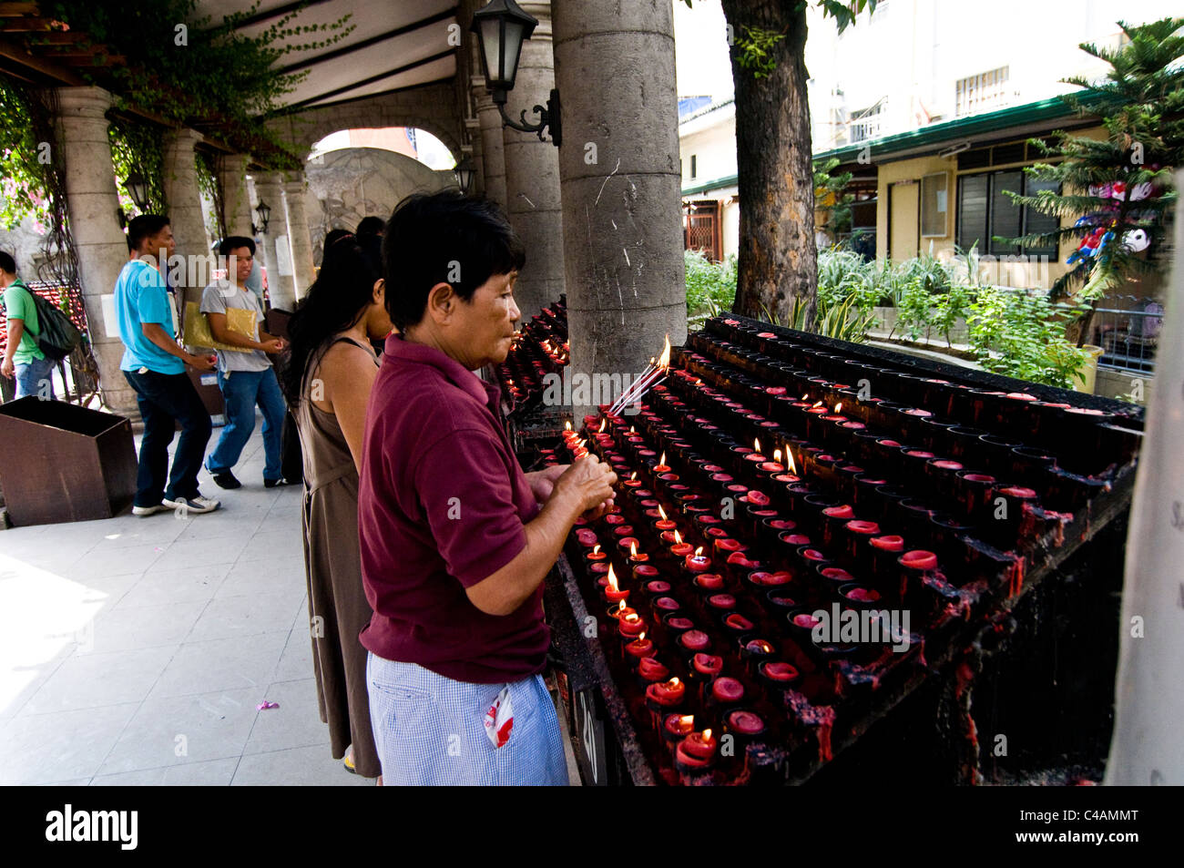 Lighting candles at the grounds of the Basilica of the Santo Niño in ...