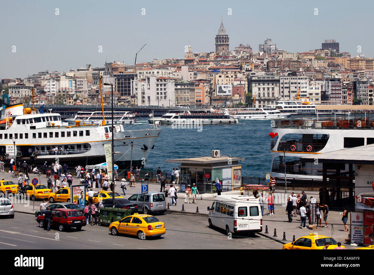 Traffic and ferries and a busy waterfront scene in the harbour in ...