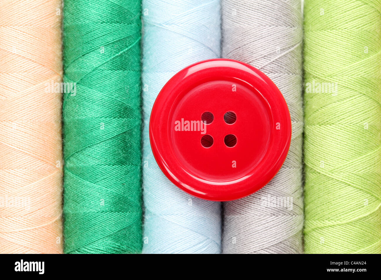 Colorful spools of thread and button, background texture Stock Photo ...
