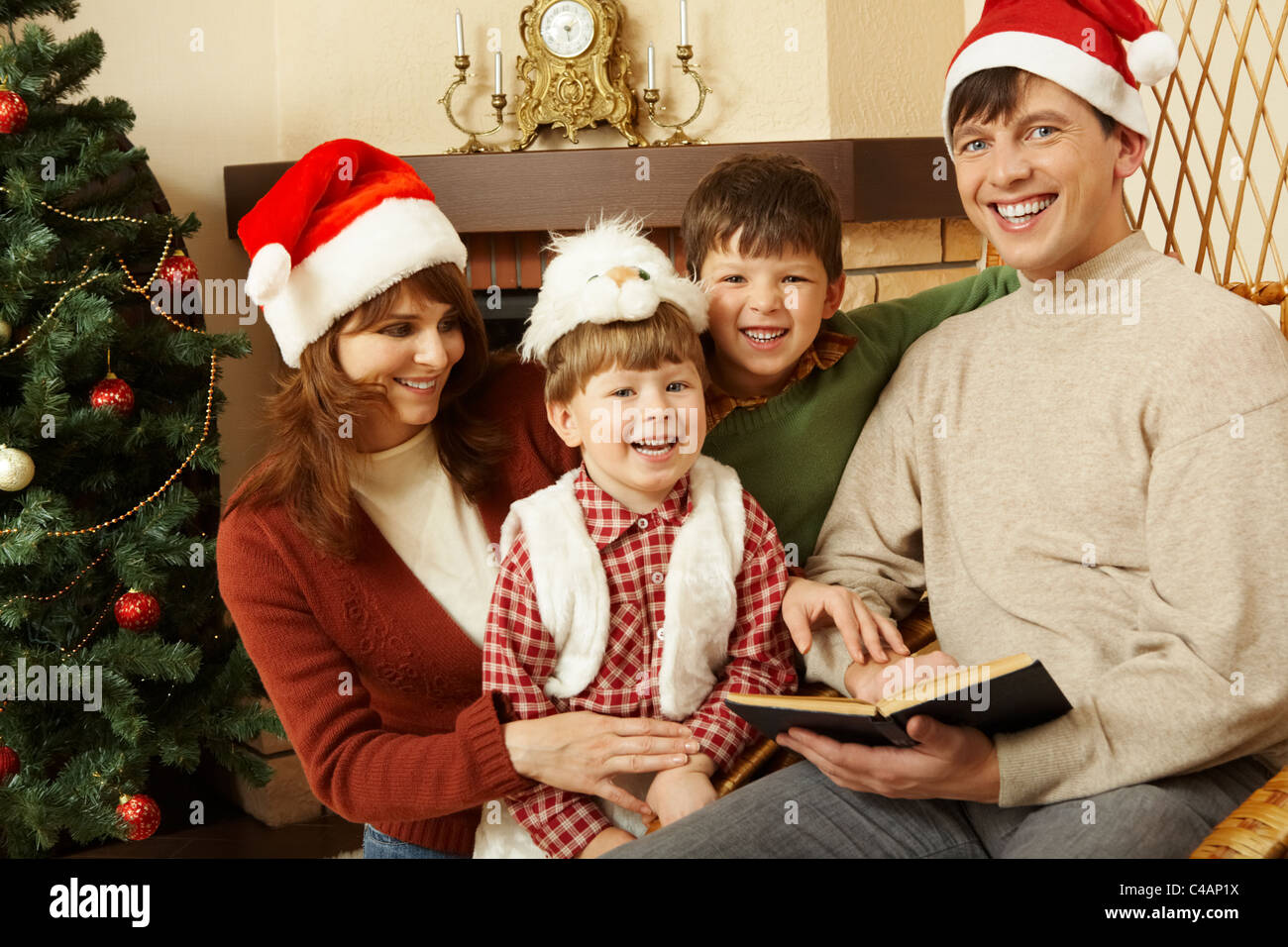 Portrait of happy family members standing next to each other and ...