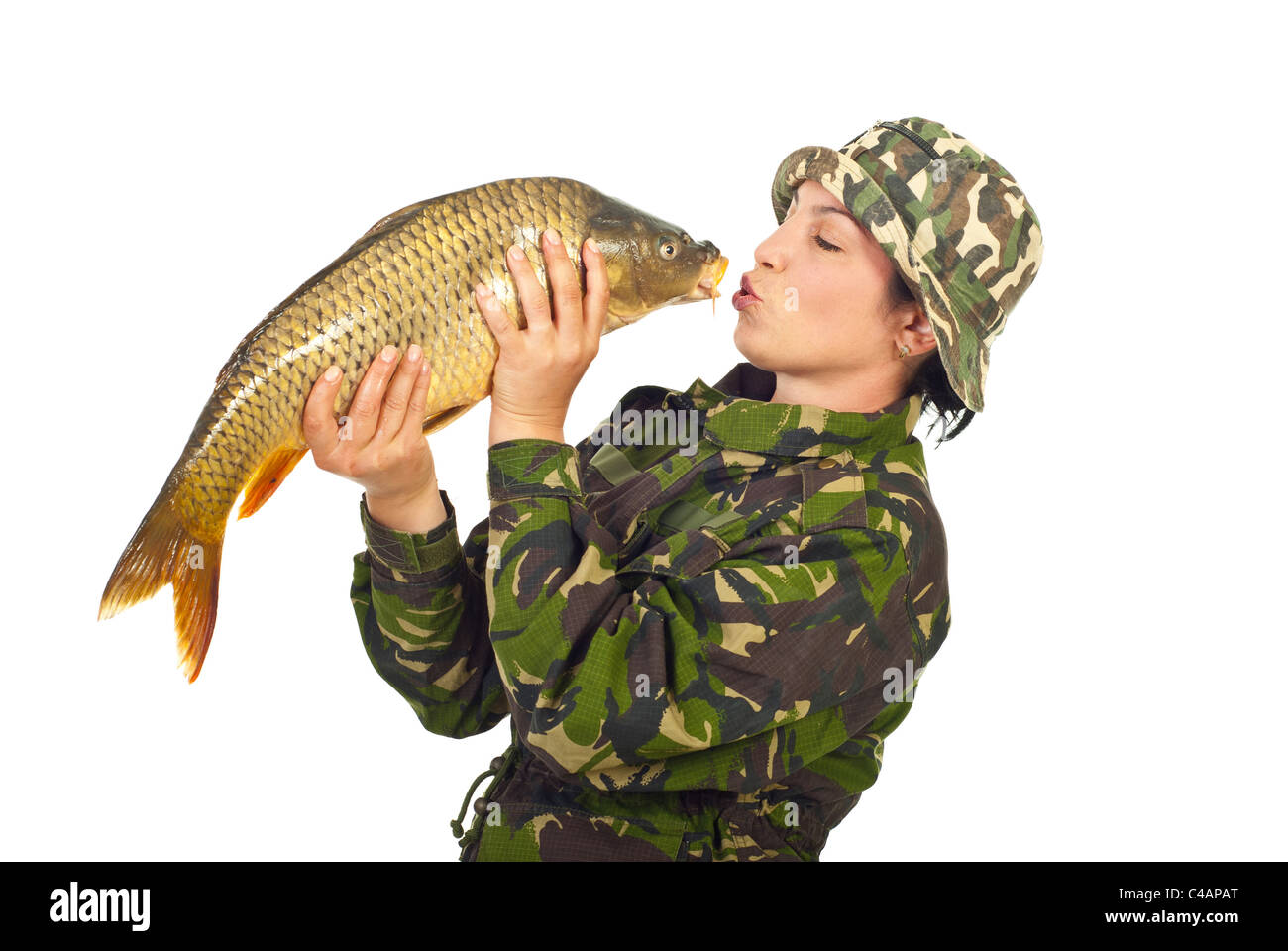 Fisher woman kissing big carp fish isolated on white background Stock ...