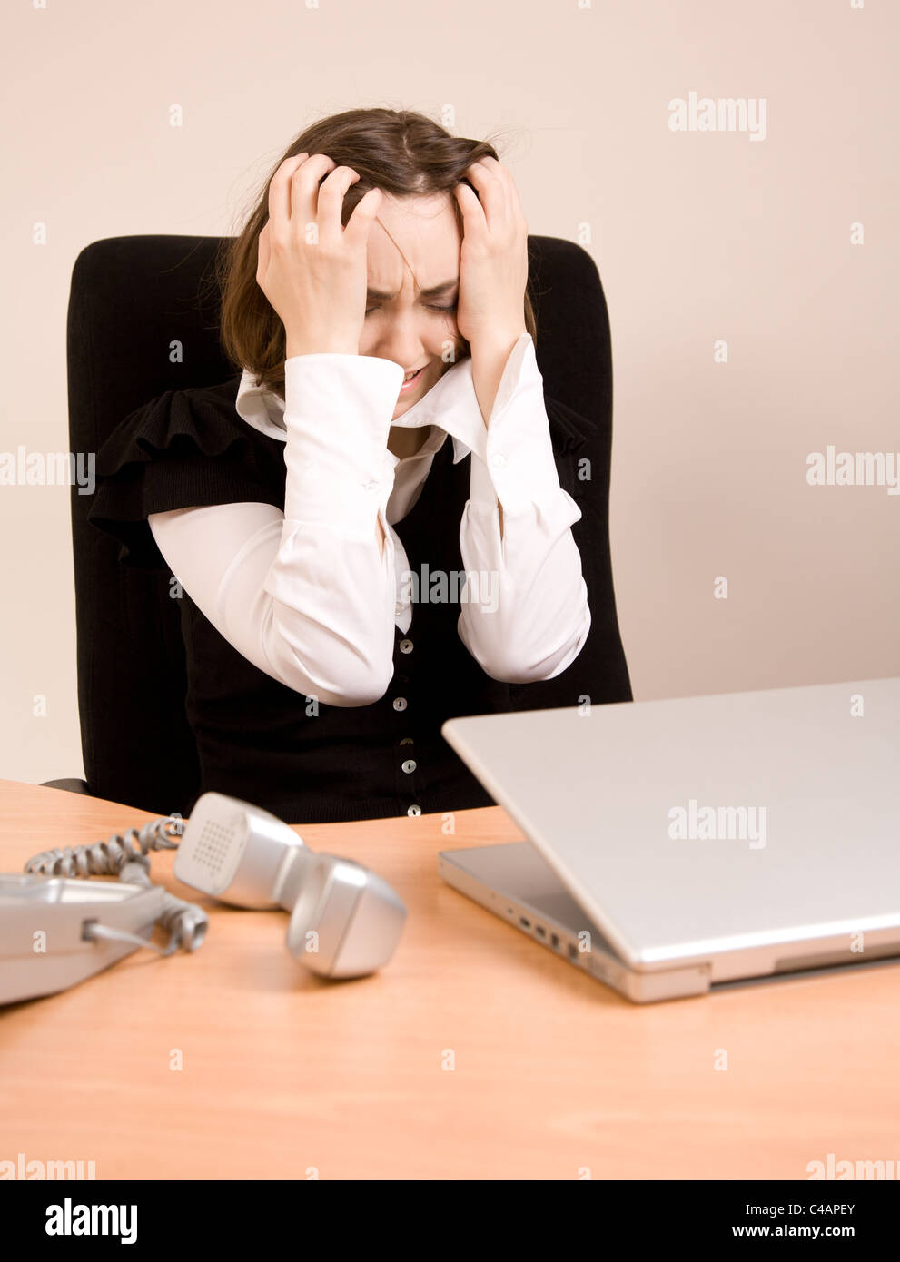 Young businesswoman sitting at the office screaming Stock Photo - Alamy