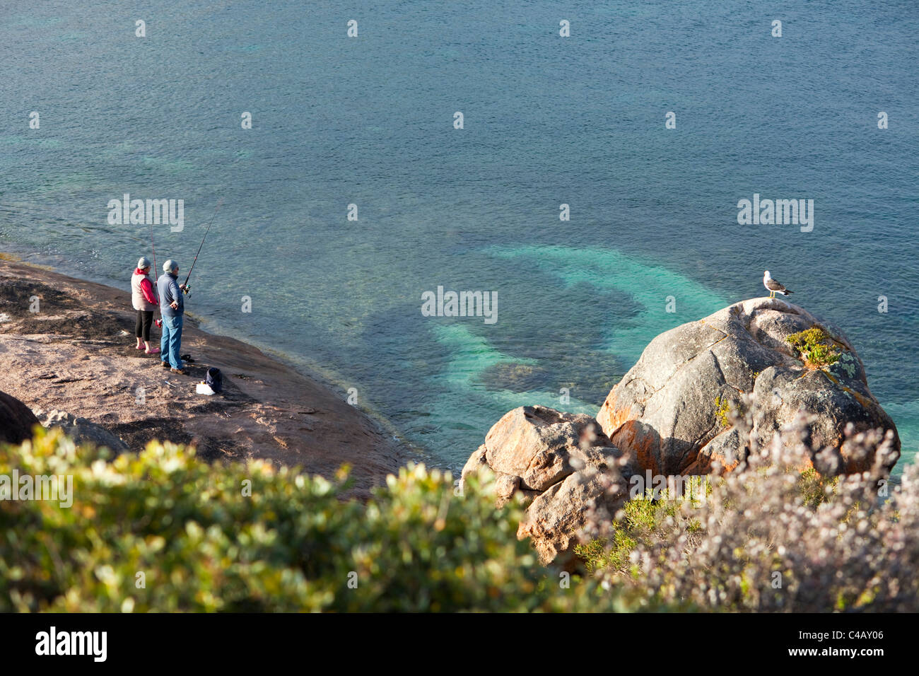 Couple fishing off rocks at Lucky Bay. Cape Le Grand National Park ...