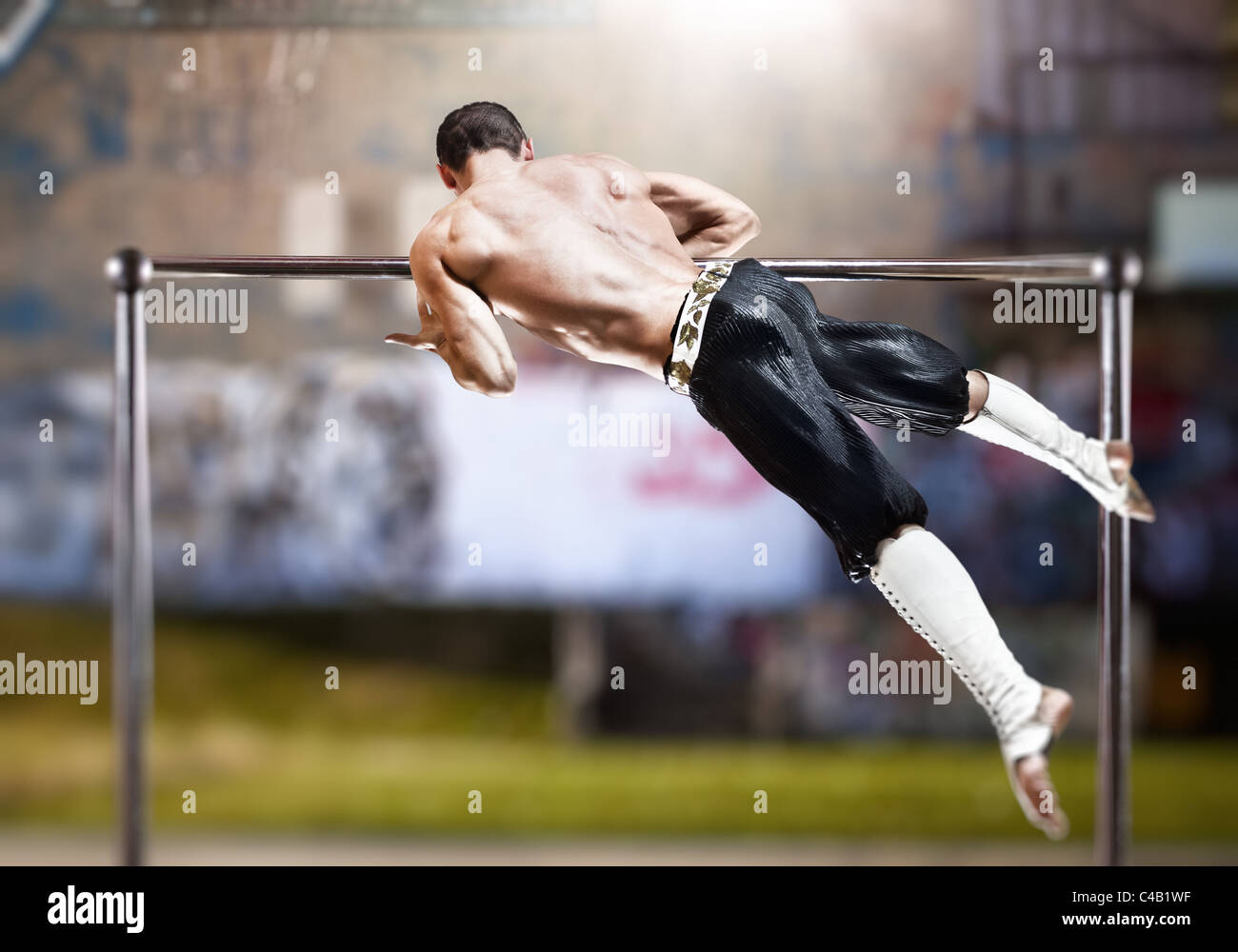 Young man doing sports exercises outdoors Stock Photo - Alamy