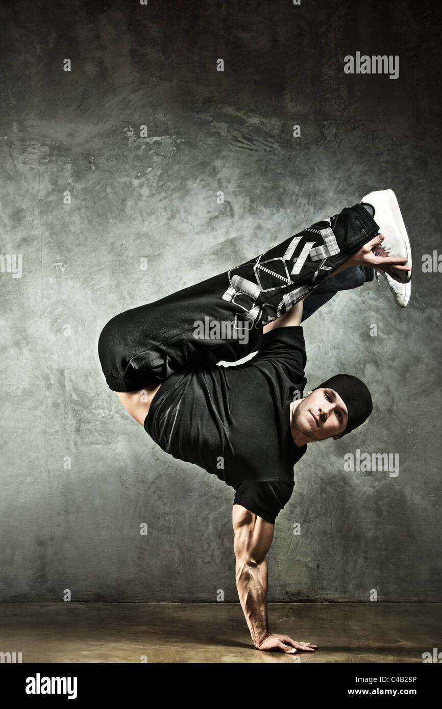 Young strong man break dance. On wall background Stock Photo - Alamy