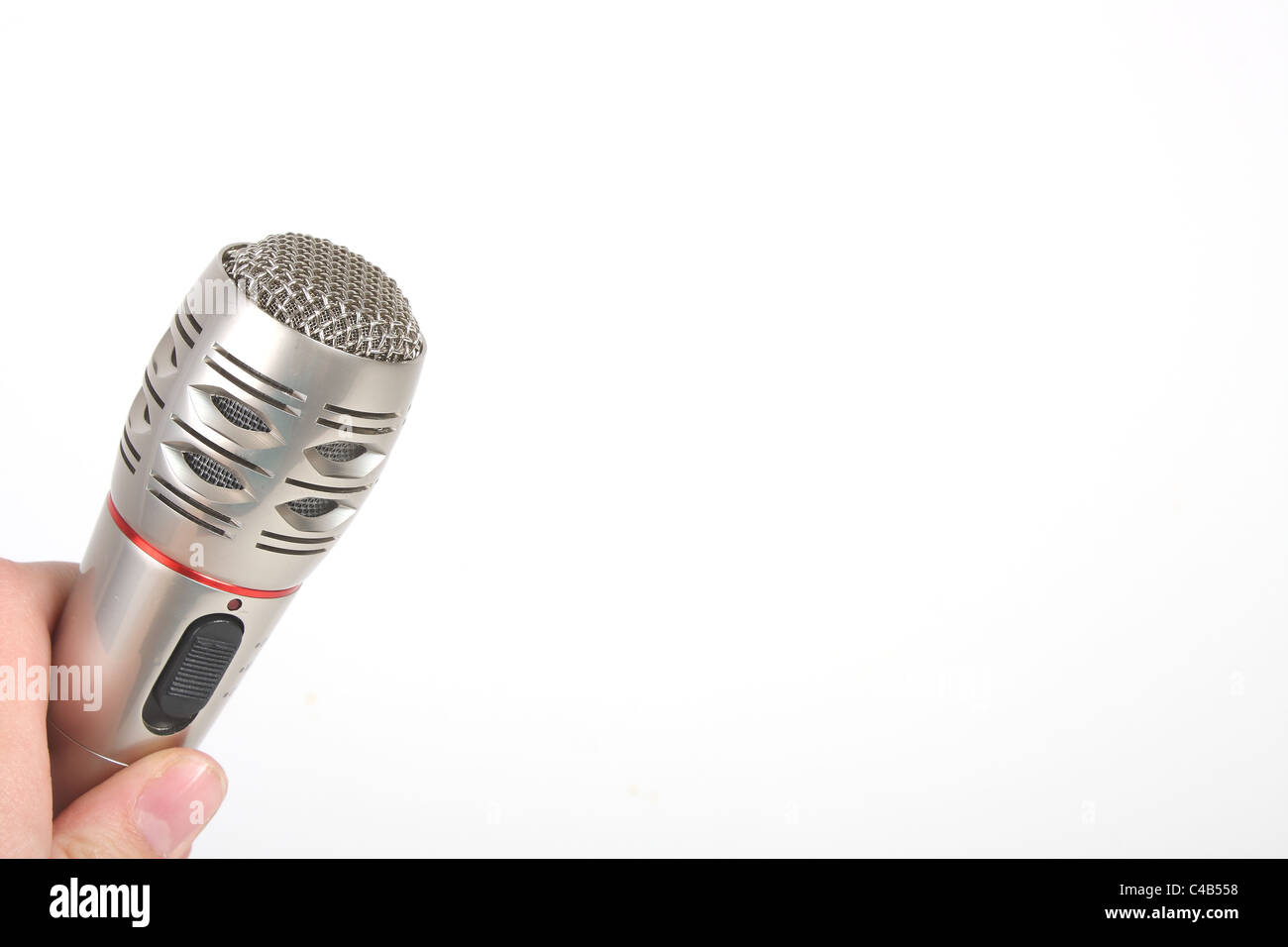 A Caucasian female holding a silver microphone on a cut out white ...