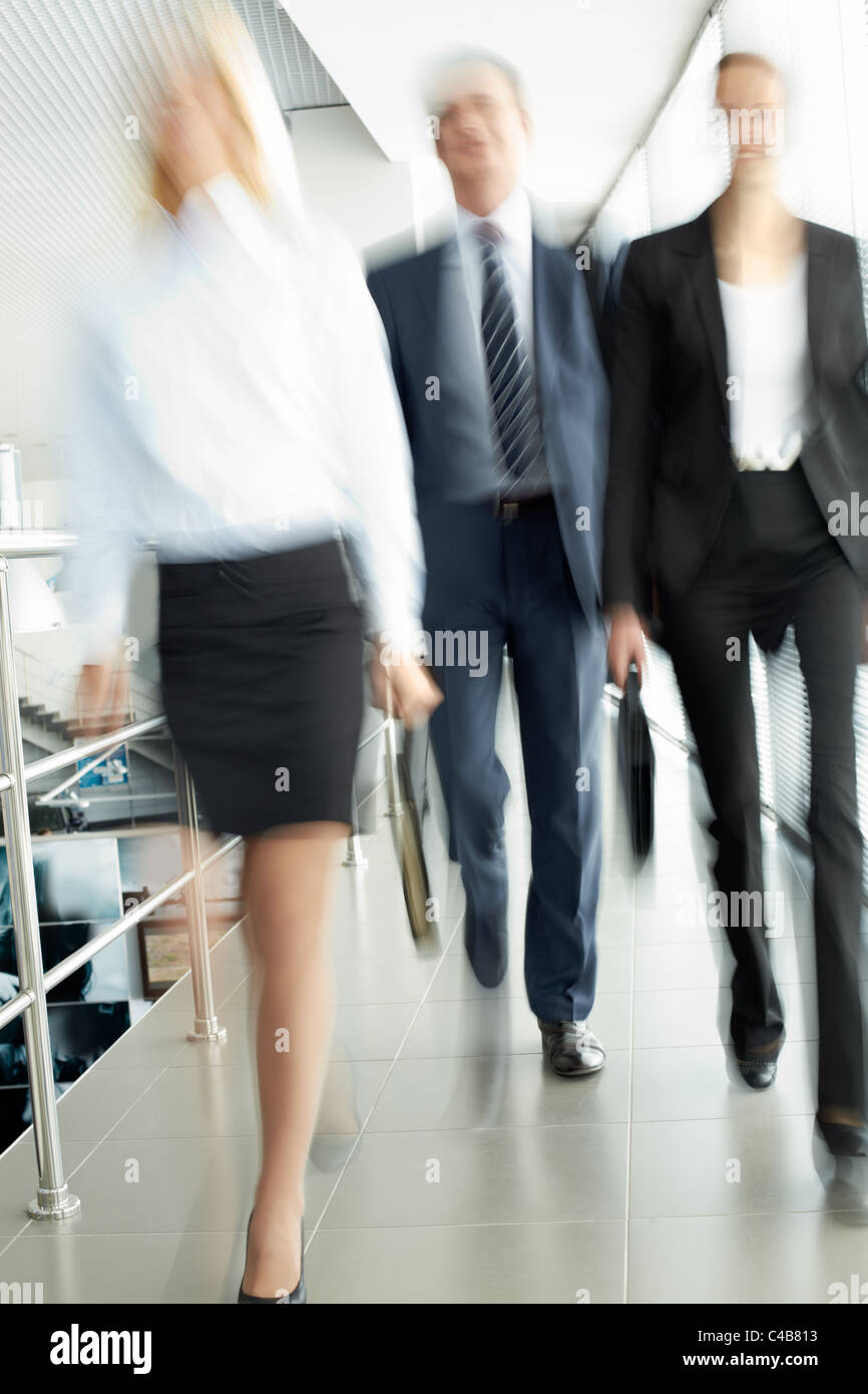 Business people walking in the office corridor Stock Photo - Alamy