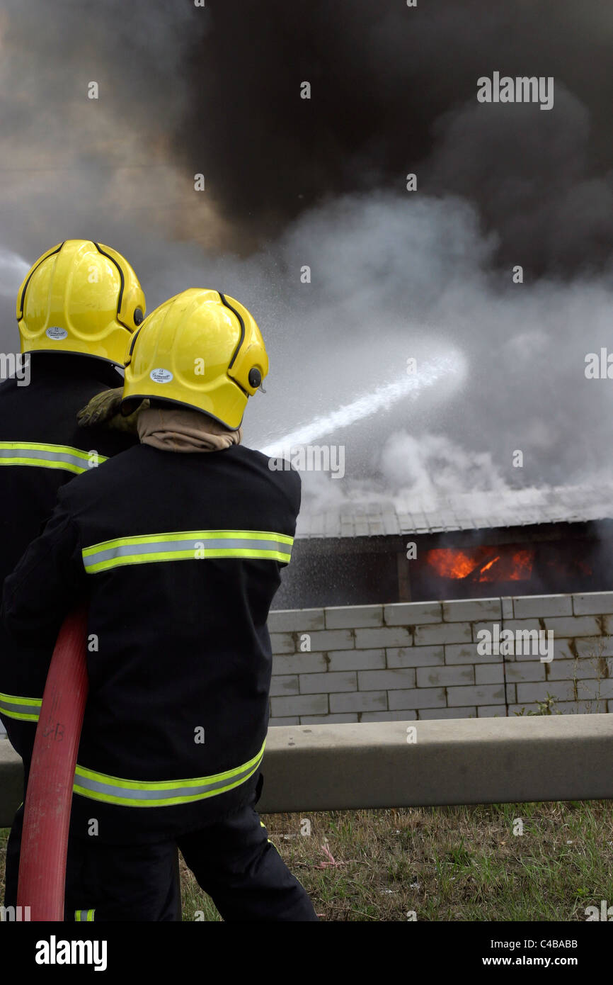 Firefighters with a main jet at the scene of a large fire in Essex ...