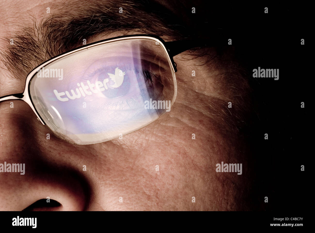 Twitter social networking site logo reflected in glasses Stock Photo - Alamy