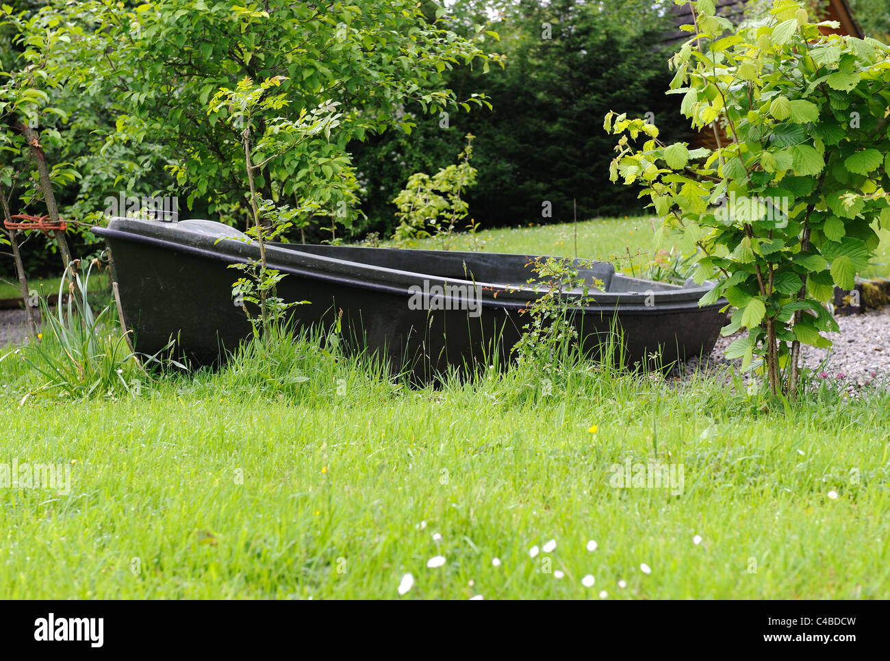 Small boat and green grass Stock Photo - Alamy