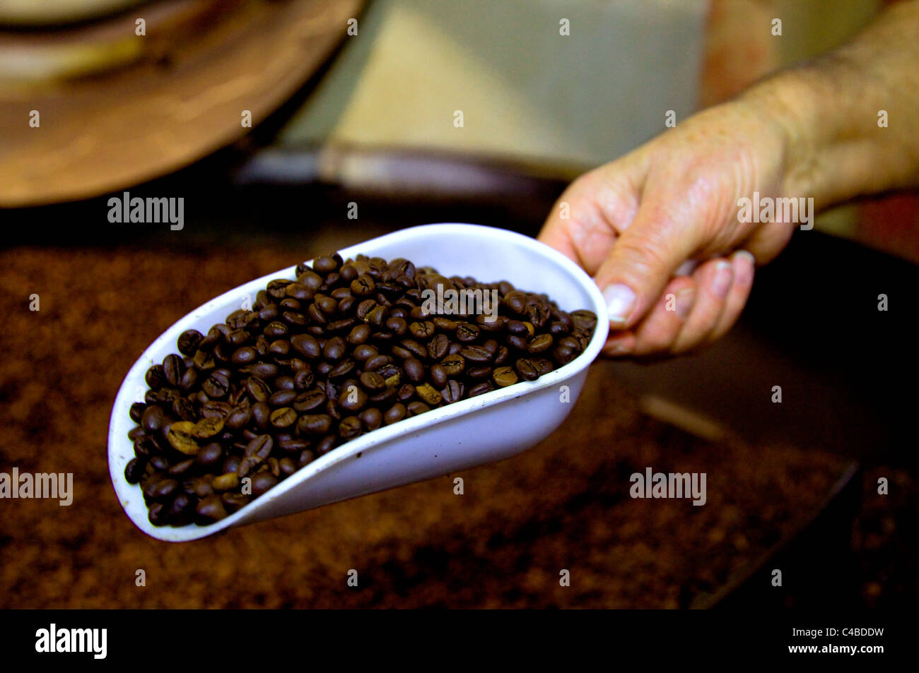 Rome, Italy; A spadeful of freshly cooked coffee beans Stock Photo - Alamy