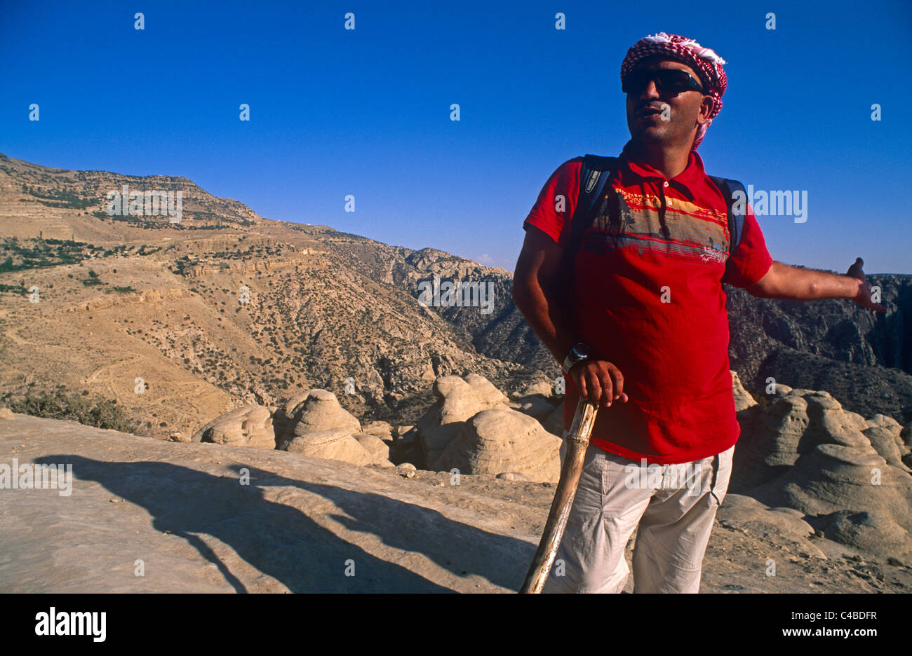 Jordan, Dana Biosphere Reserve. A Jordanian guide pauses on the 'Dana ...