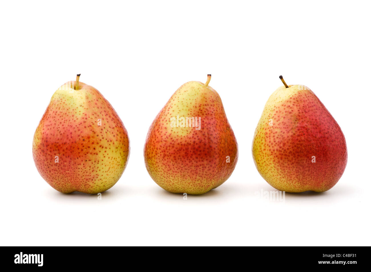 Three pears, arranged in a row, isolated, white background Stock Photo ...