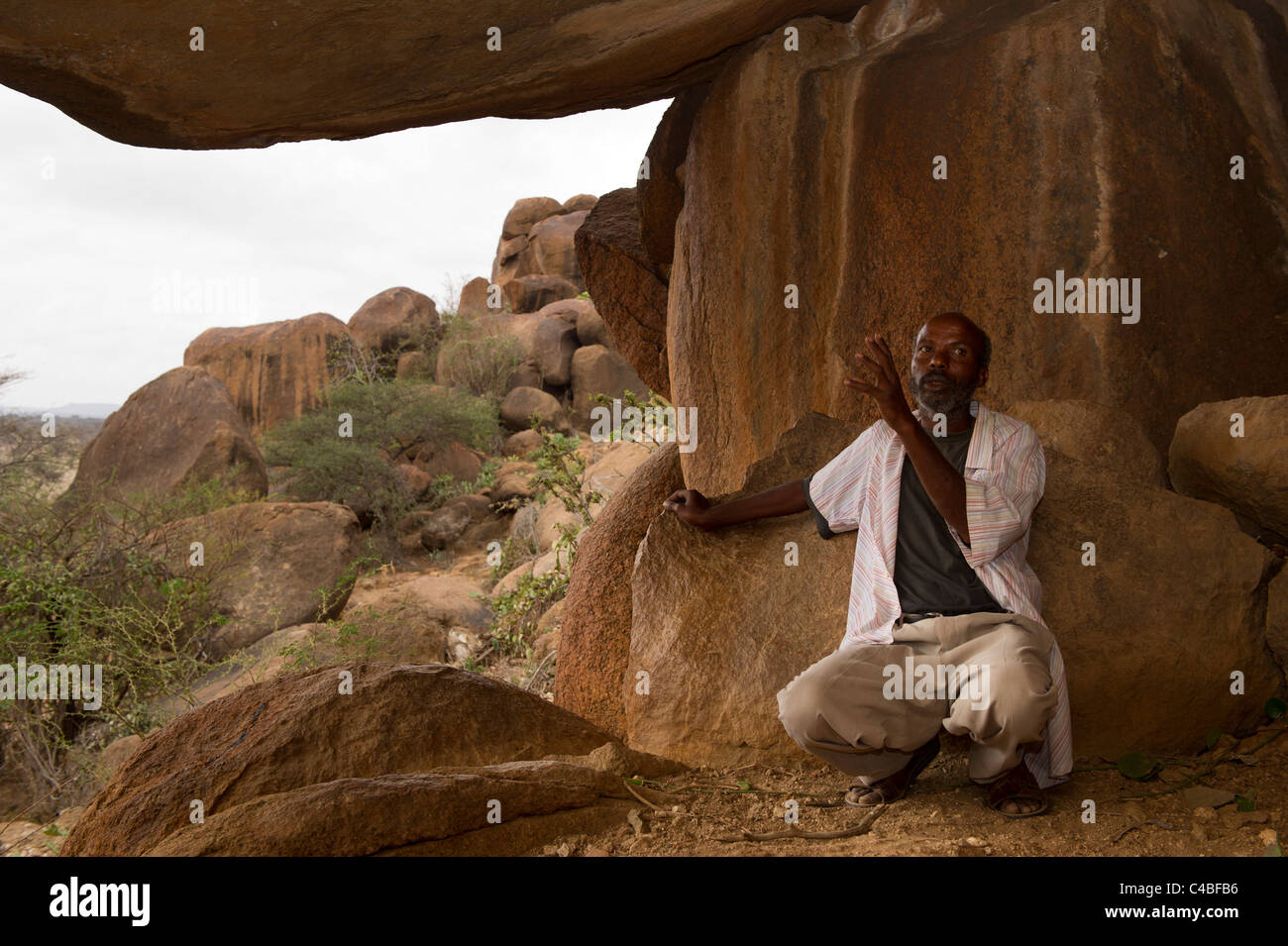 man looking at Dhagax Khoure, ancient rock-art, Somaliland, Somalia ...