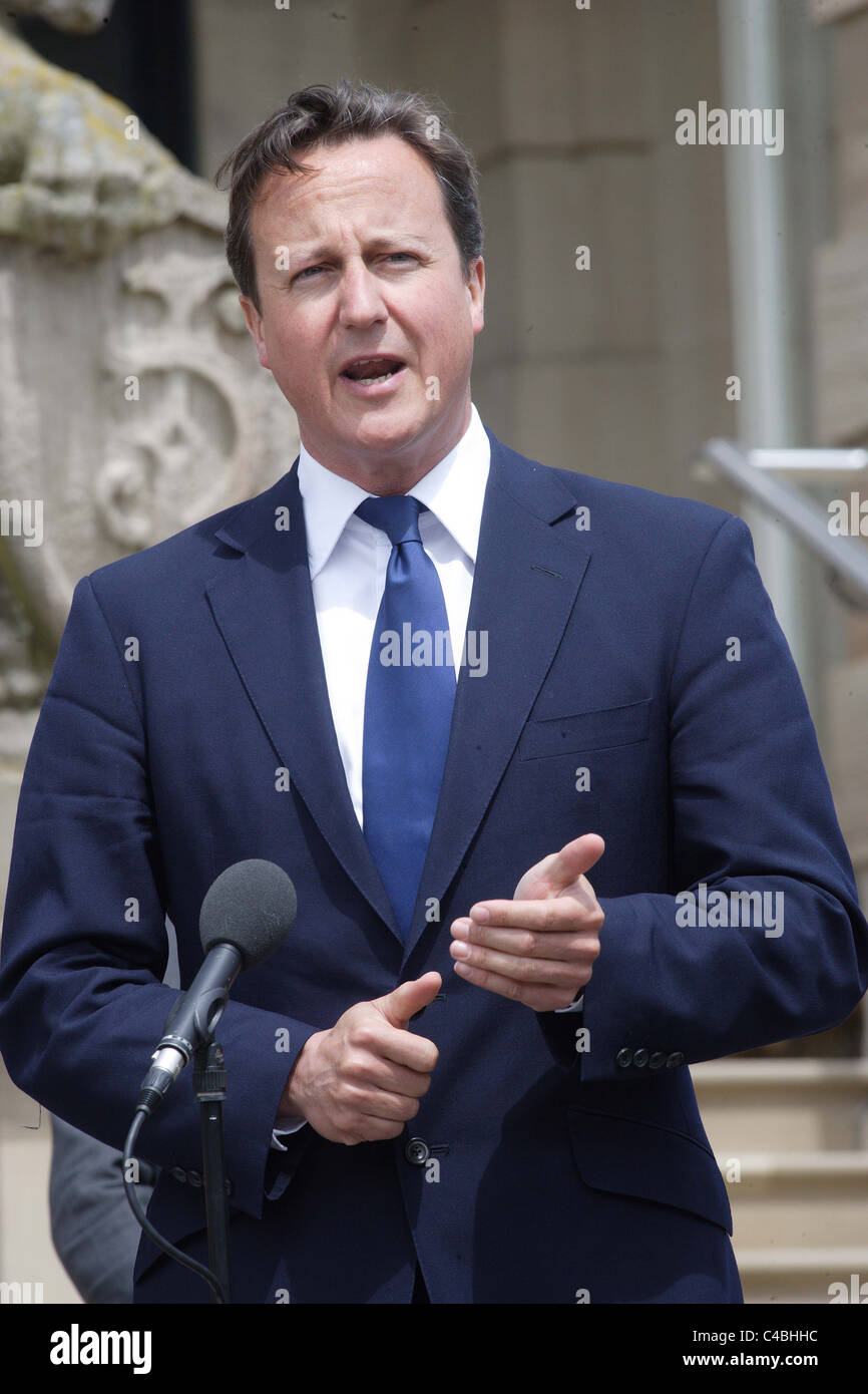 Britain's David Cameron speaks to the media outside Stormont Castle ...