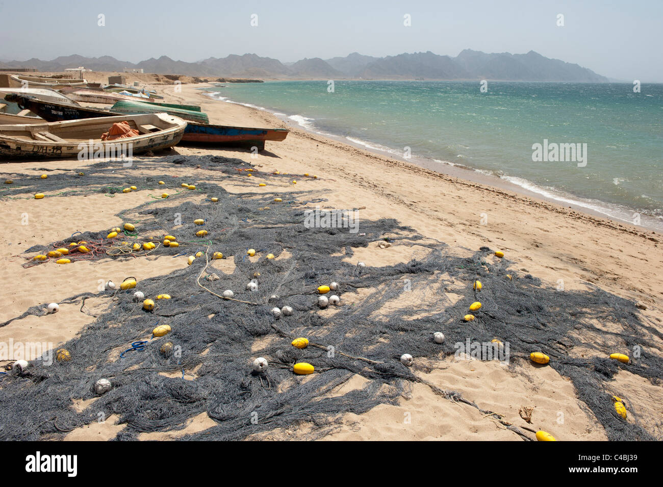 Fishing nets and boats on the beach at Maydh village, Gulf of Aden ...