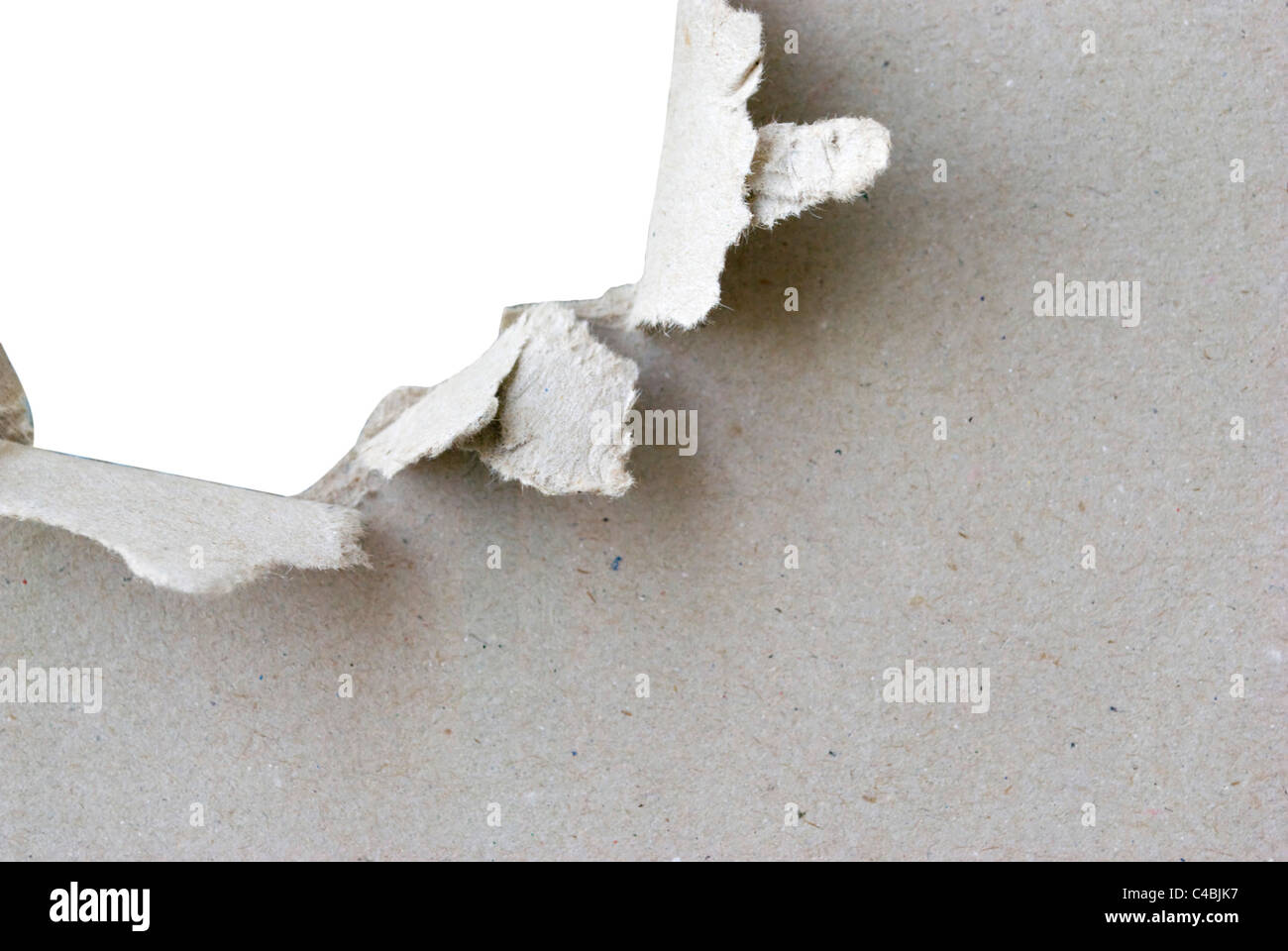 torn hole in sheet of paper with white background and copyspace Stock ...