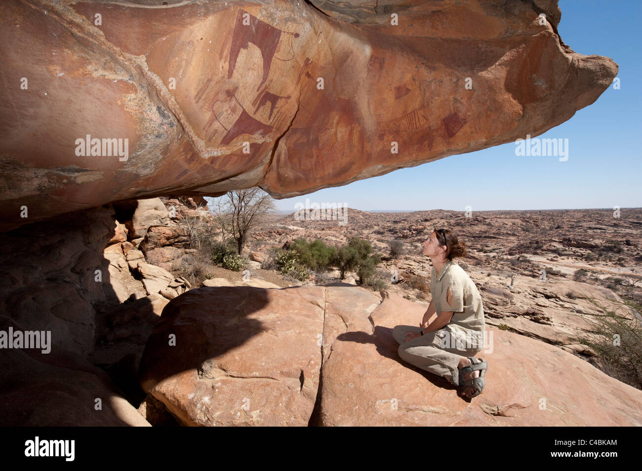 Tourist looking at Las Geel rock-art, Somaliland, Somalia Stock Photo ...