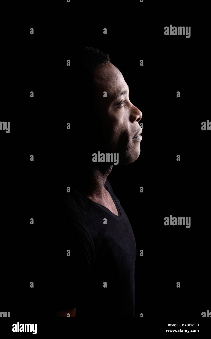 profile of young black man. isolated on black background Stock Photo ...