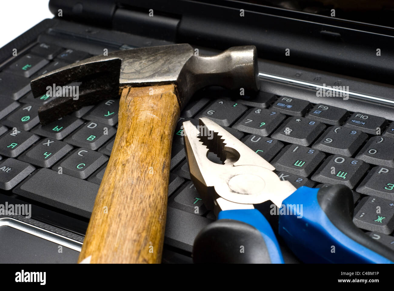 hammer and pliers on a laptop Stock Photo - Alamy