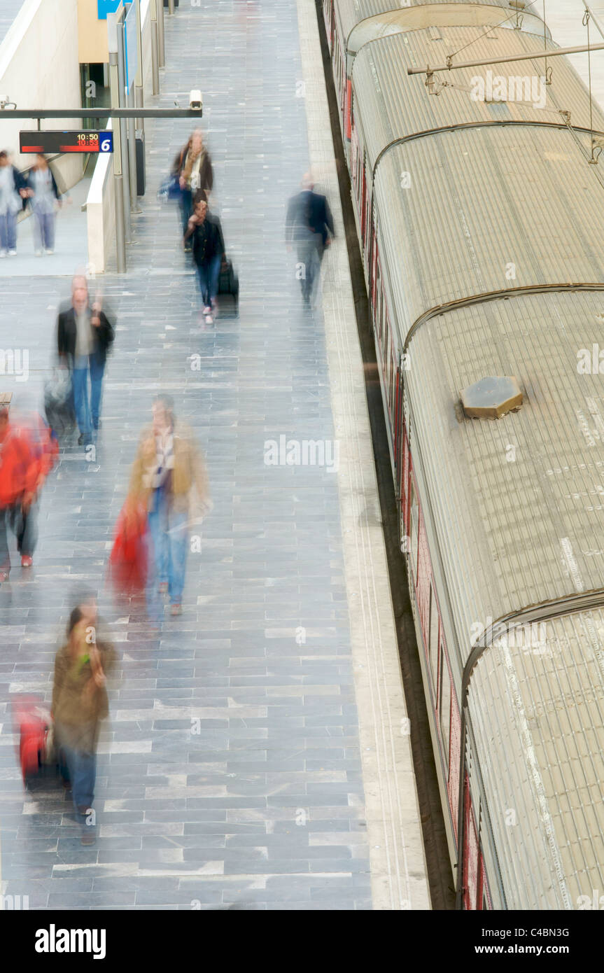 Passengers walking through the platform of a train station Stock Photo ...