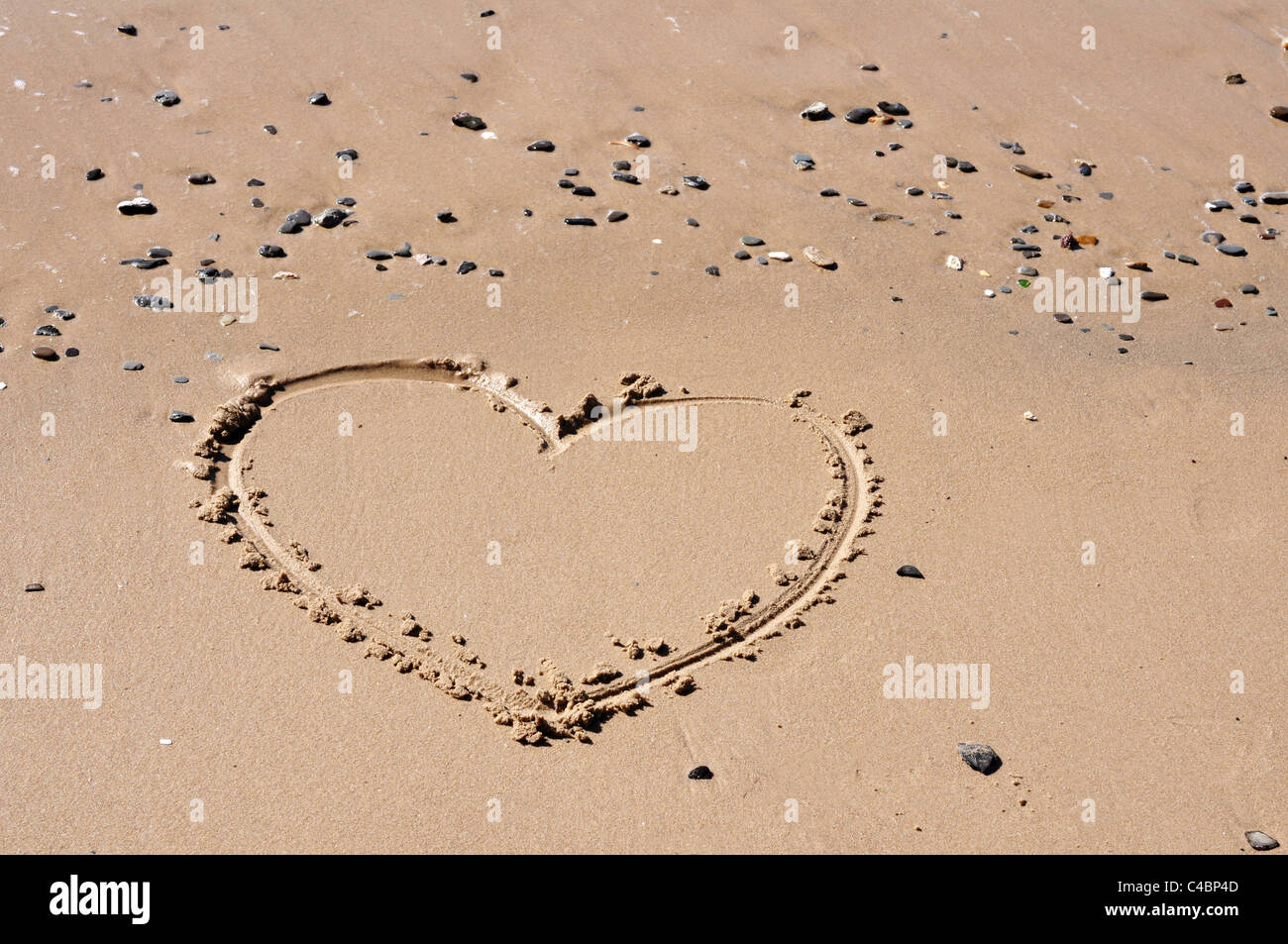 A heart shape in the sand Stock Photo - Alamy
