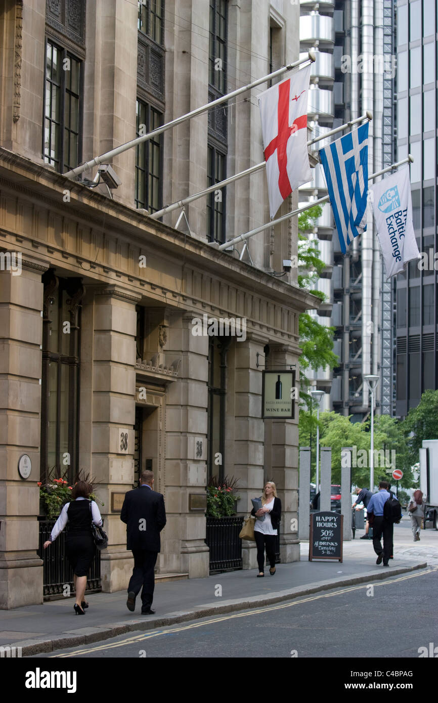 The Baltic Exchange building, City of London UK, with the flags of ...