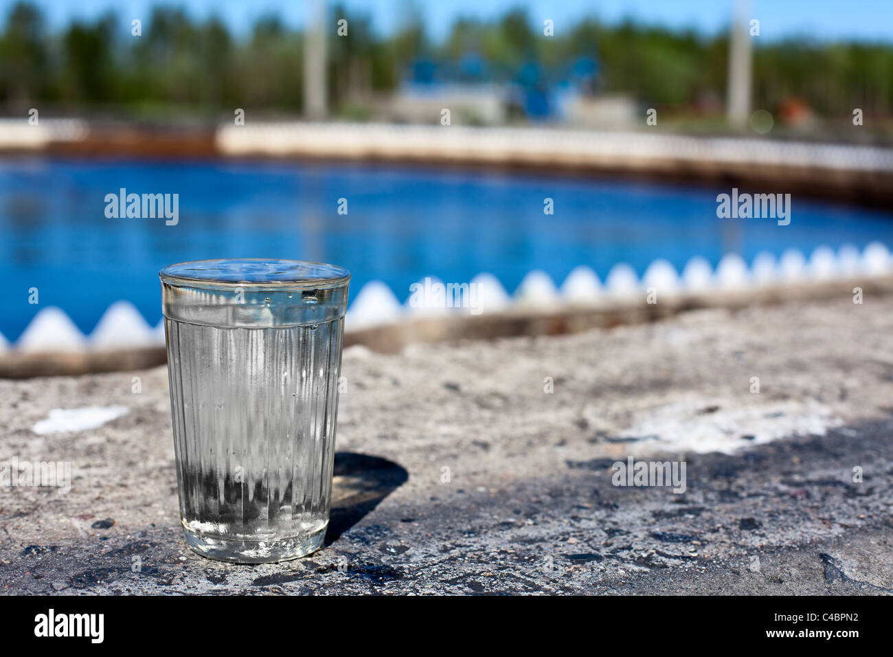 Glass with flow liquid in water treatment plant Stock Photo - Alamy