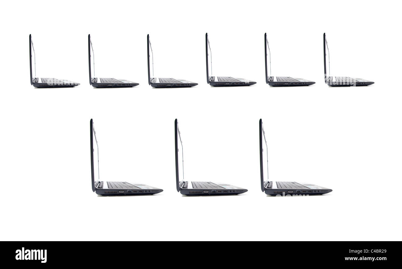 A side view of several black laptops in front of a white background ...