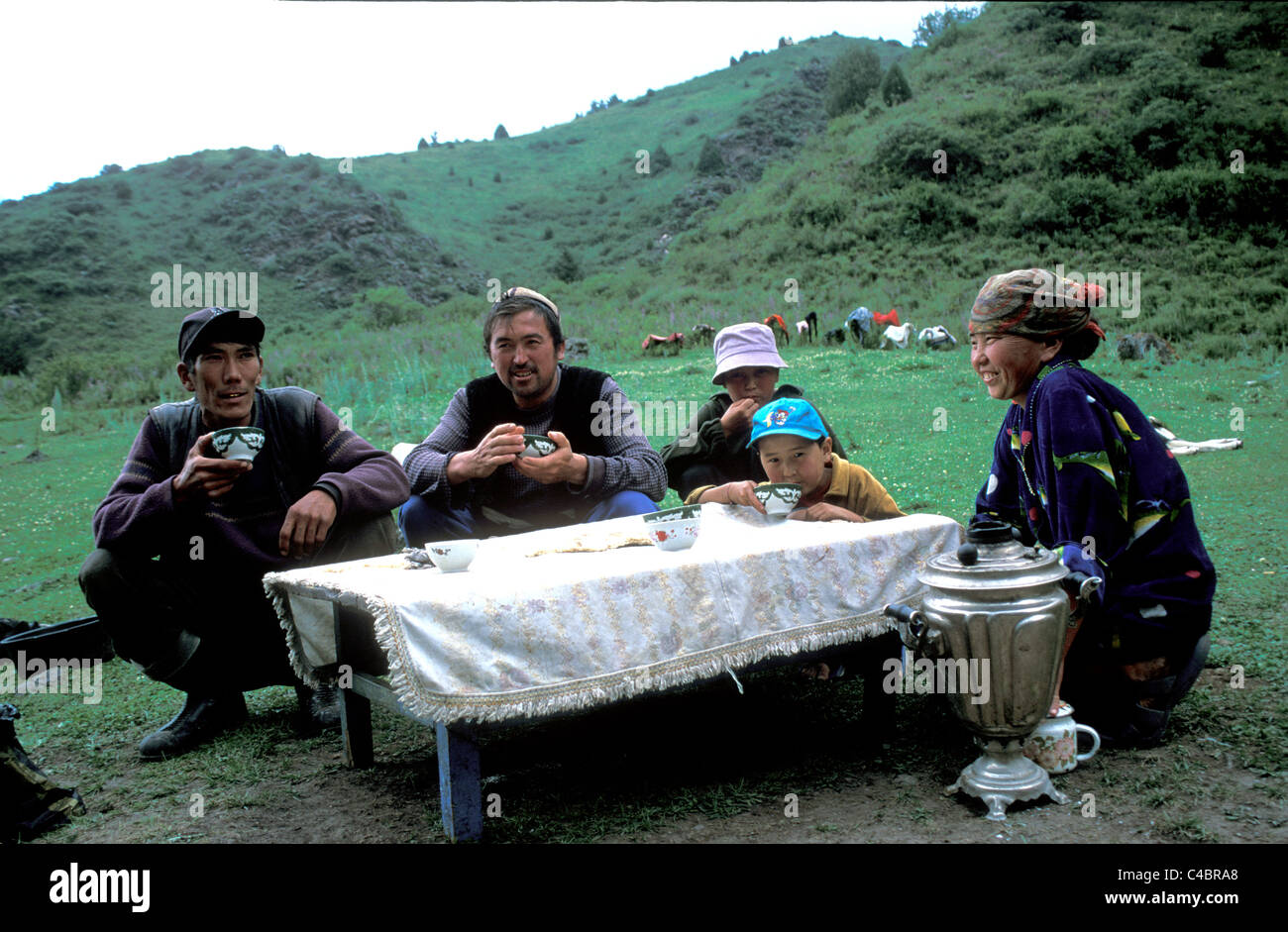 Kyrgyz family drinking tea in front of the yurt Stock Photo - Alamy