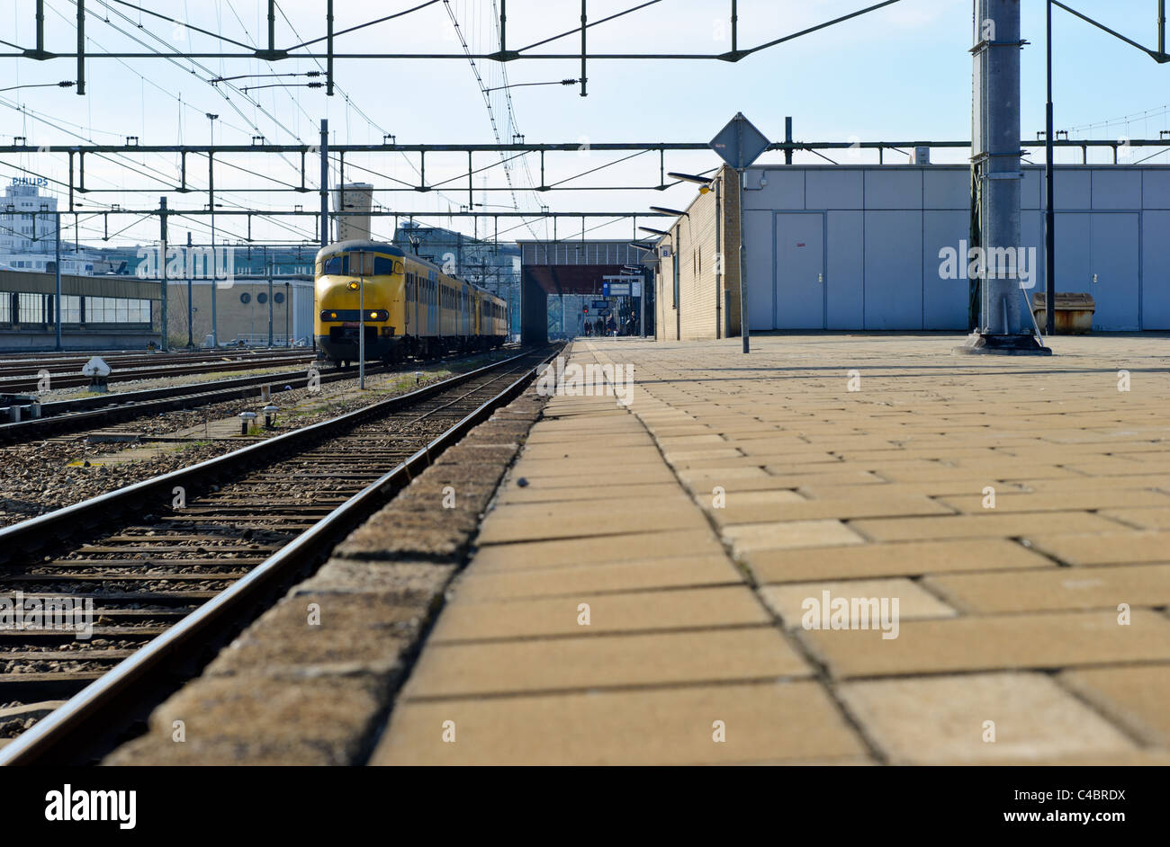 train platform with people waiting for train at a trainstation Stock ...