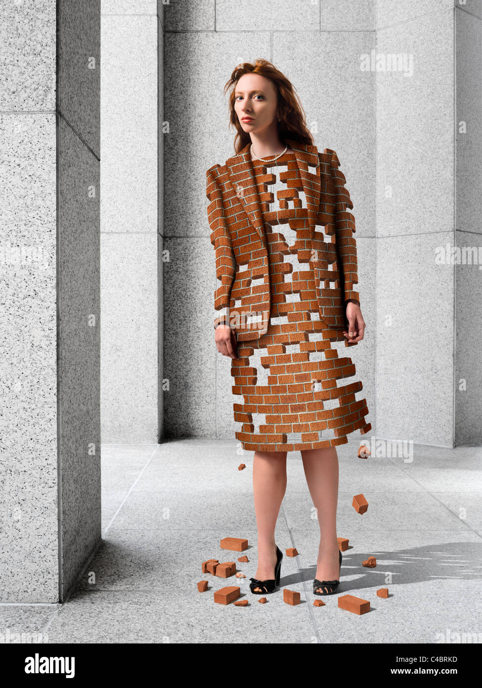 woman made of bricks that are breaking apart, standing in outdoor plaza ...